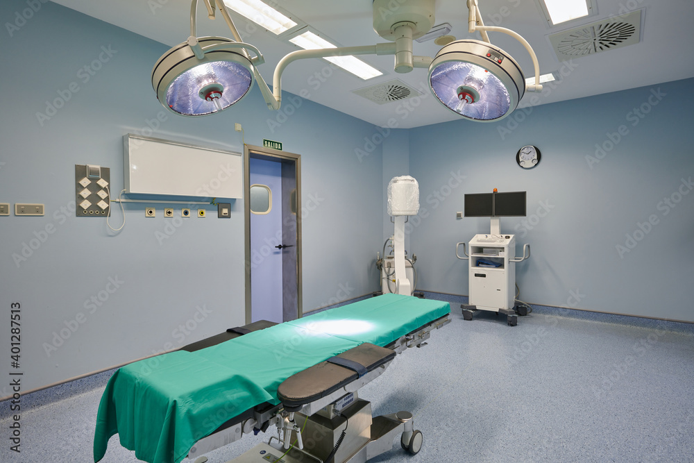 Contemporary operating room interior with couch under shiny lamps near ...