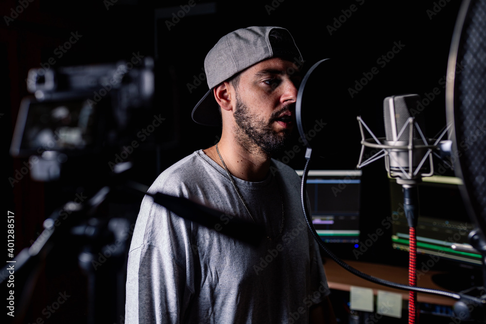 Confident male singer in music recording studio and shooting video on ...