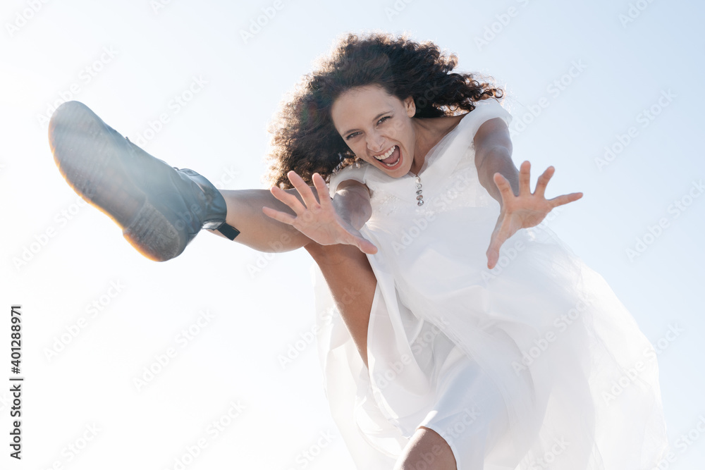 From below of ethnic female with curly hair and open mouth stretching ...