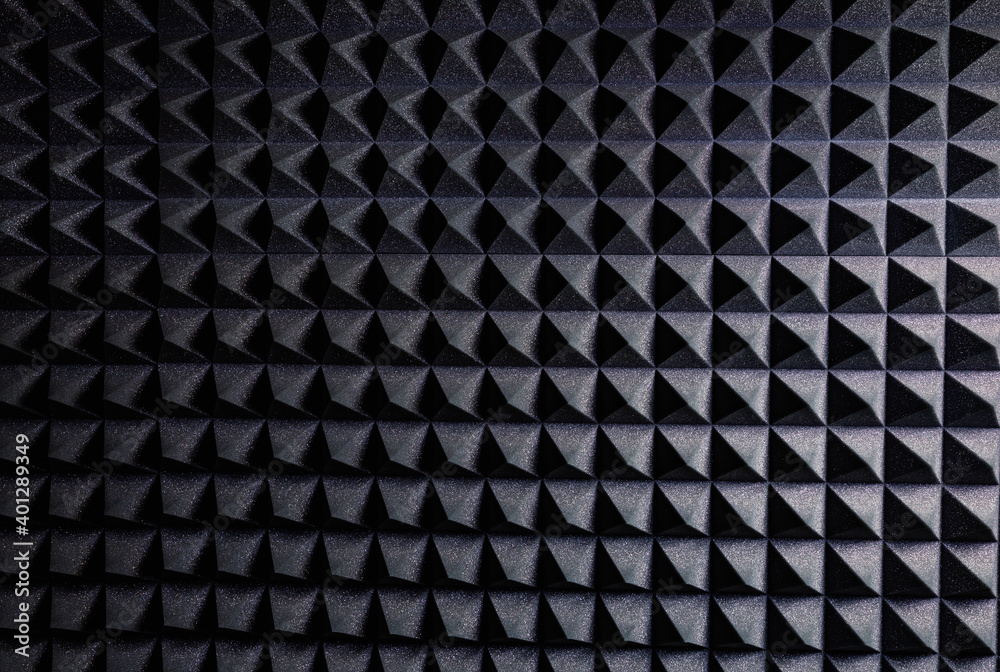 Textured background of wall with black geometric soundproof foam with ...