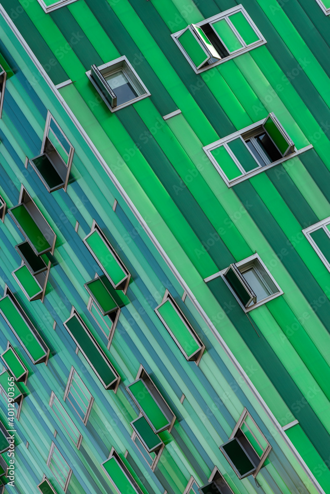 Corner of part of contemporary building with vivid green facade and ...