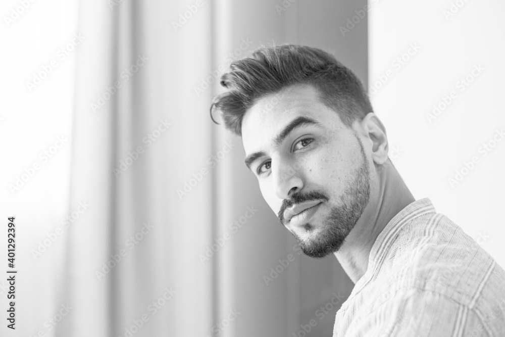 Black and white side view of young ethnic bearded male with stylish ...