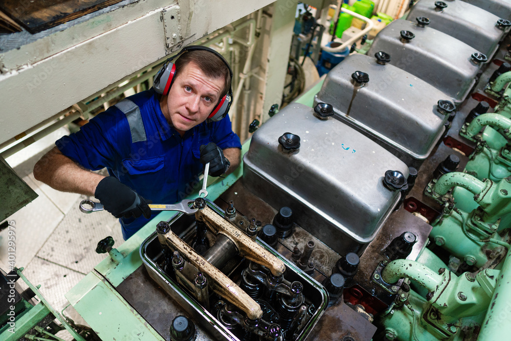 Marine engineer officer reparing vessel engines and propulsion in ...