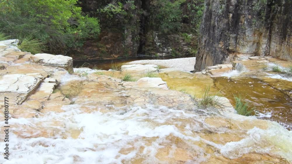 Top view of a waterfall with the water stream running by sedimentary ...