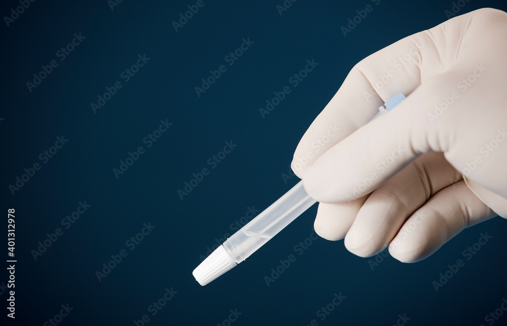 Laboratory scientist with vial and swab indoors performing a rapid ...