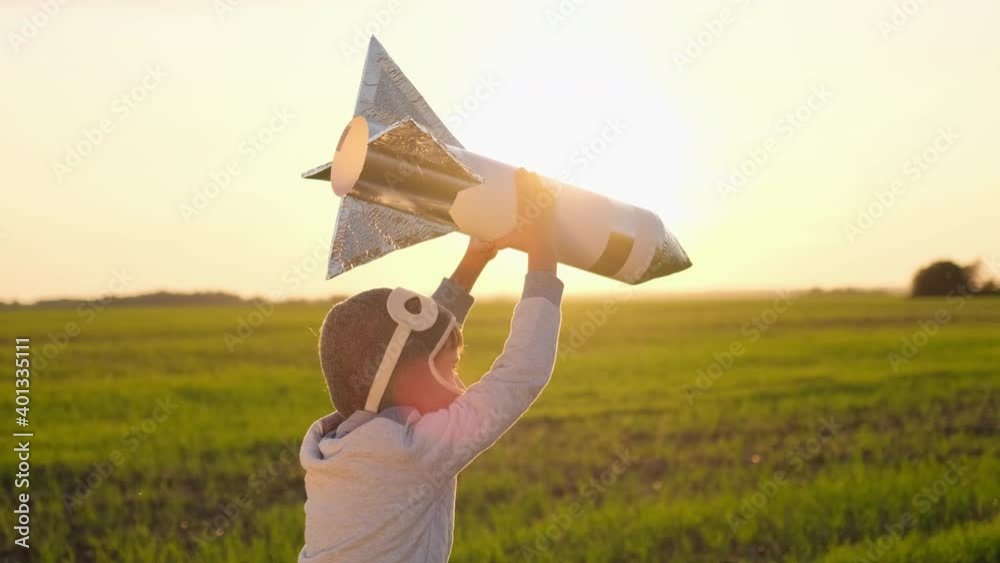 Back of little boy child in helmet aviator cosmonaut running with toy ...
