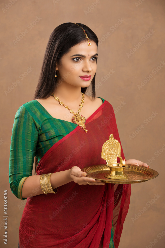 Hindu Indian young women holding Deepam in hands studio shot ...