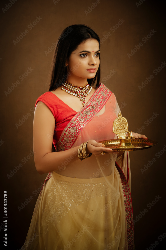 Hindu Indian young women holding Deepam in hands studio shot ...