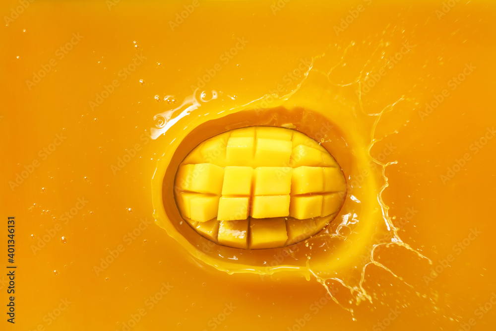Falling of fresh mango into juice Stock Photo | Adobe Stock