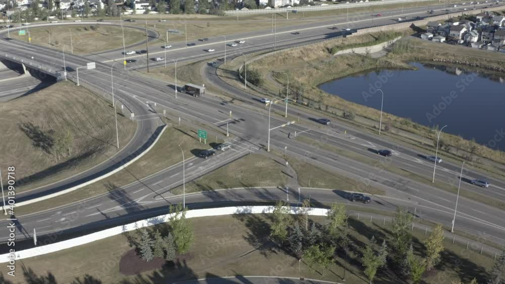 Aerial early morning over sunny summer highway freeway exit enterance ...