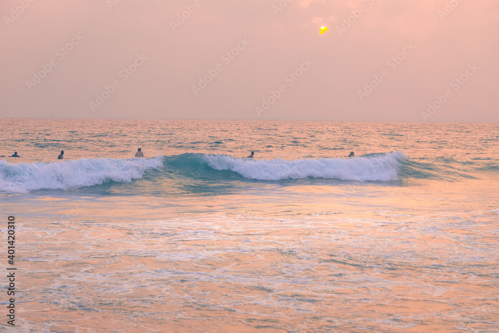Ocean waves under beautiful sunset sky with sun disc, falling over ...