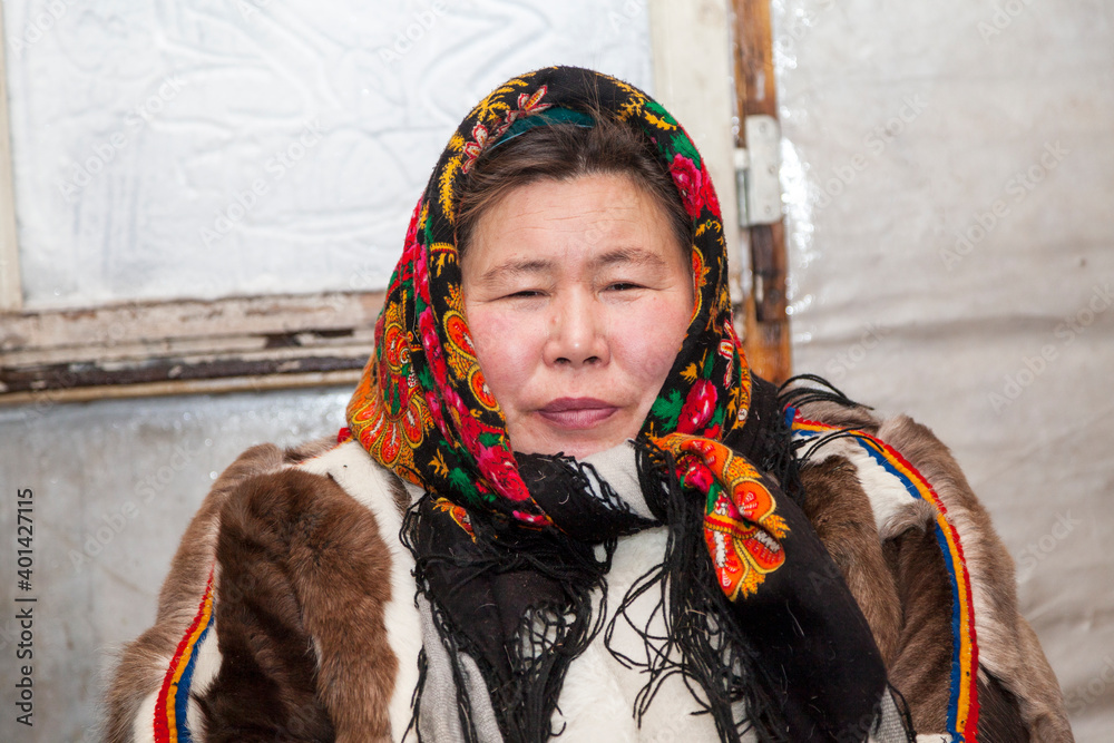 woman in the national winter clothes of the northern inhabitants of the ...