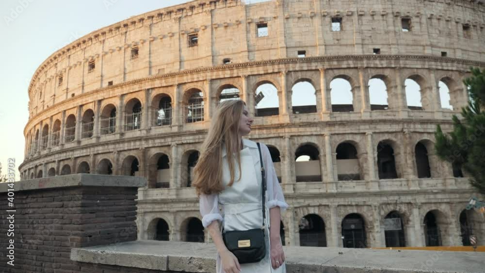 Beautiful girl is photographed in Rome near the Colosseum. A girl makes ...