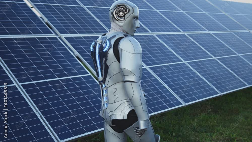 Solar farm. Back view of the smart innovative robot prototype examining ...