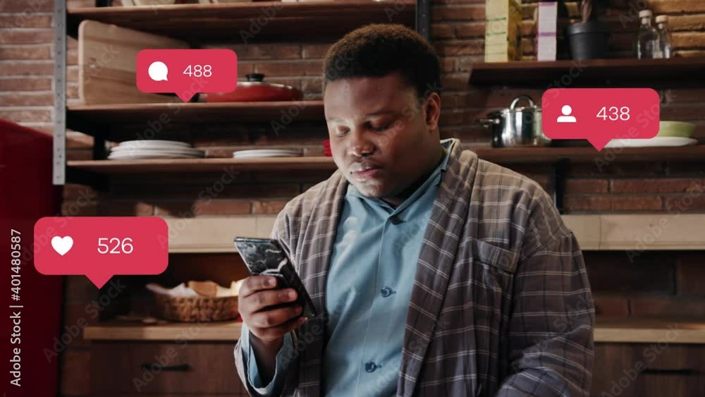 African american happy fat man standing in kitchen browsing social ...