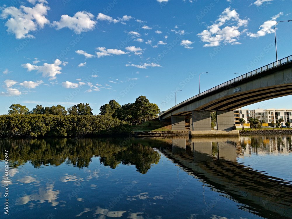 Beautiful view of a river with reflections of bridge, modern apartment ...