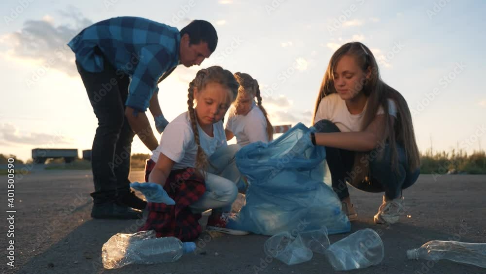 Volunteers father and daughters take away plastic waste. Happy family ...