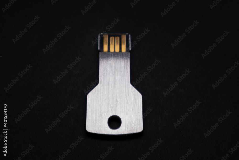 USB flash drive in the form of a key, which symbolizes data protection ...