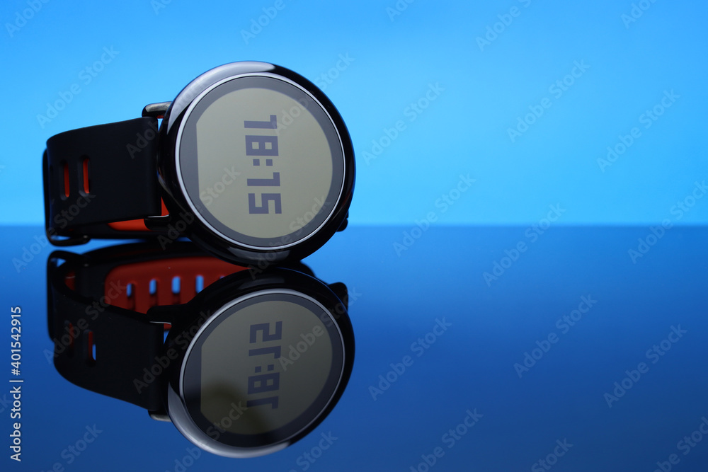 Touch smartwatch with a round display on a mirrored blue surface Stock ...