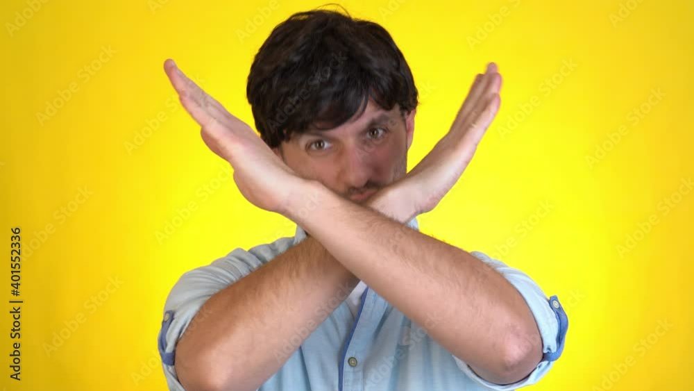 Displeased worried young man posing isolated on yellow background ...