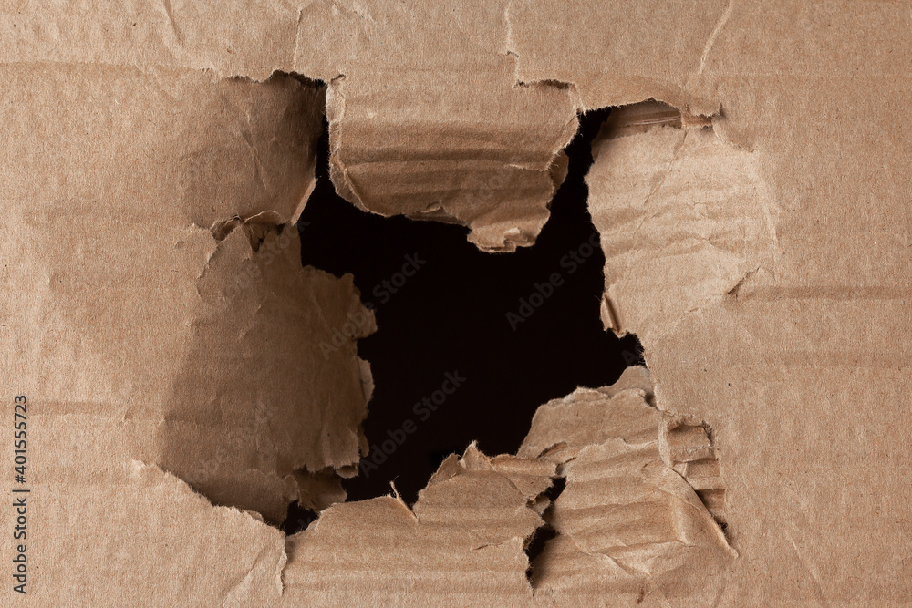 Black torn hole in a cardboard sheet Stock Photo | Adobe Stock