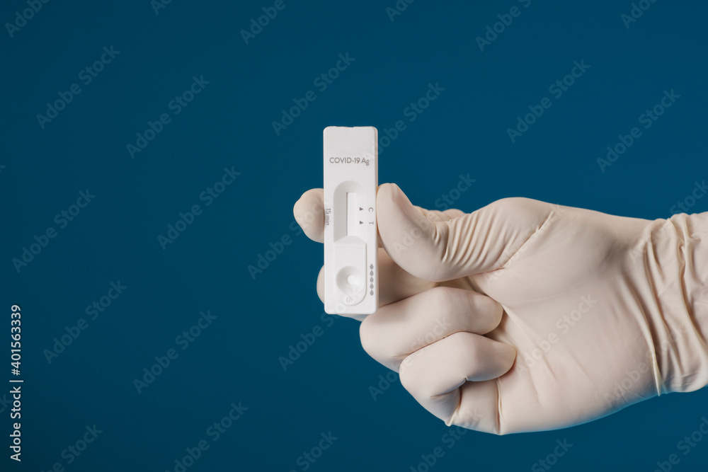Doctor holding a test kit for viral disease tests with the COVID-19 ...