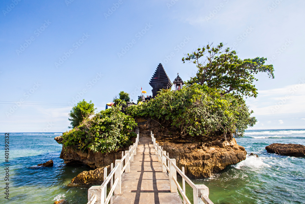 A hinduism temple in a small island in Bale Kambang beach, a tourist ...