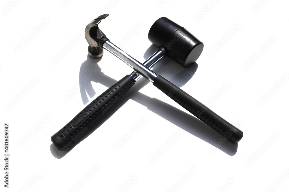 Black rubber hammer and iron hammer cross intersect isolated on white ...