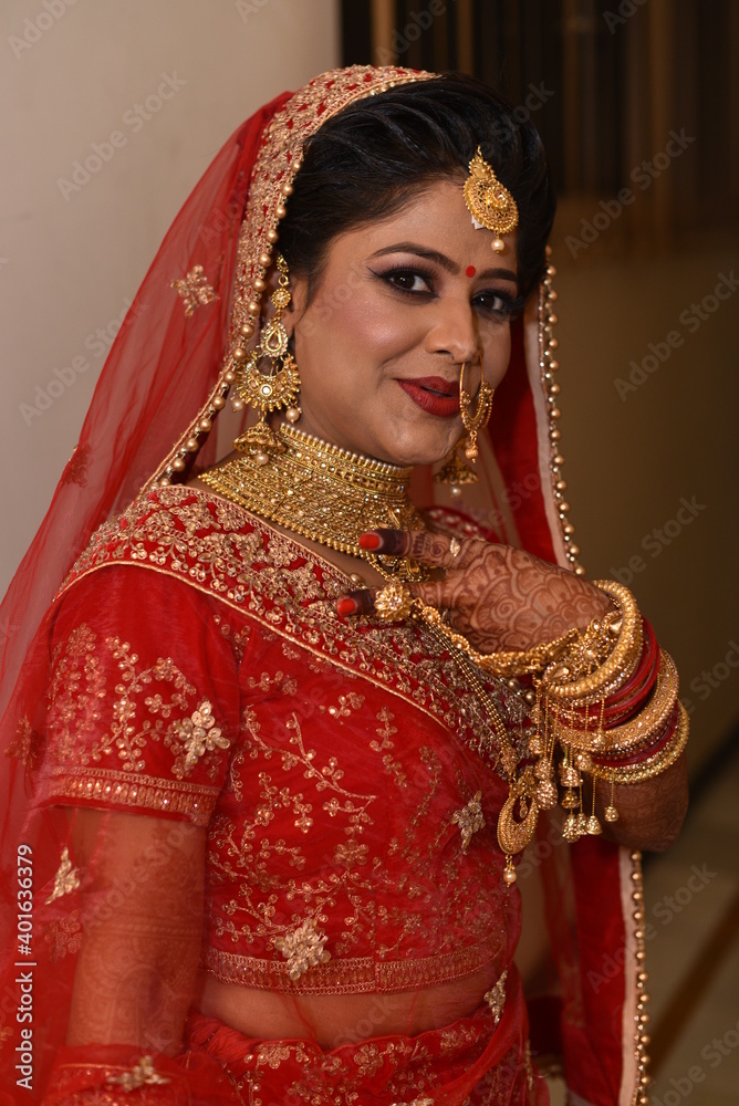 Cute Indian bride posing with victory sign for photograph Stock Photo ...