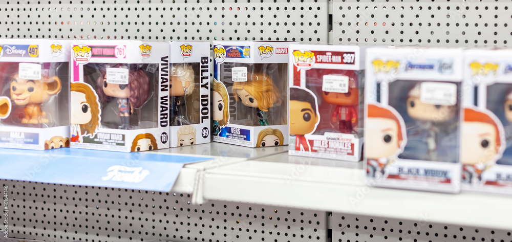 Lots of Funko Pop figurines packed in boxes in a row on a shop display ...