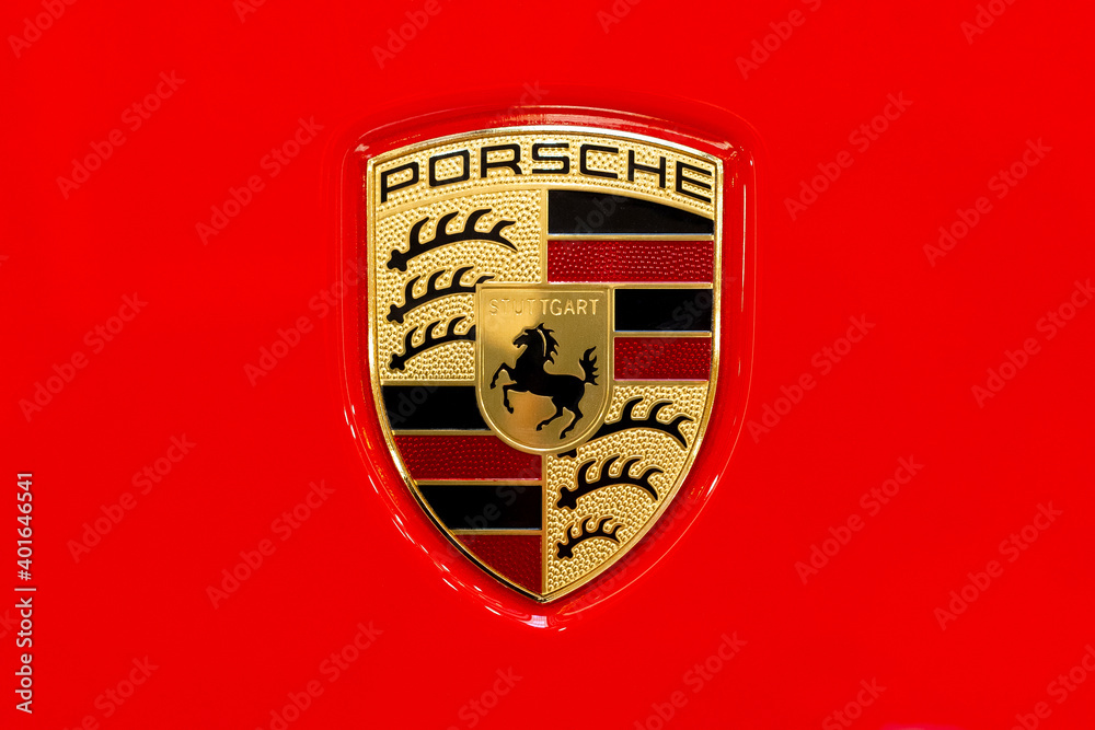 Porsche car brand logo on a shiny red car hood closeup, macro, detail ...