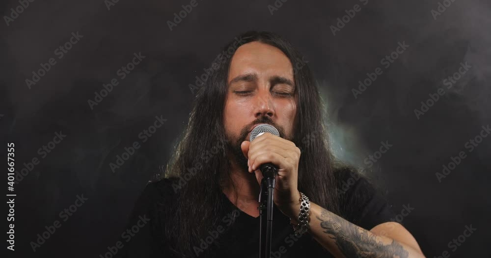 Dramatic close-up portrait of a long-haired Caucasian male, brunet with ...