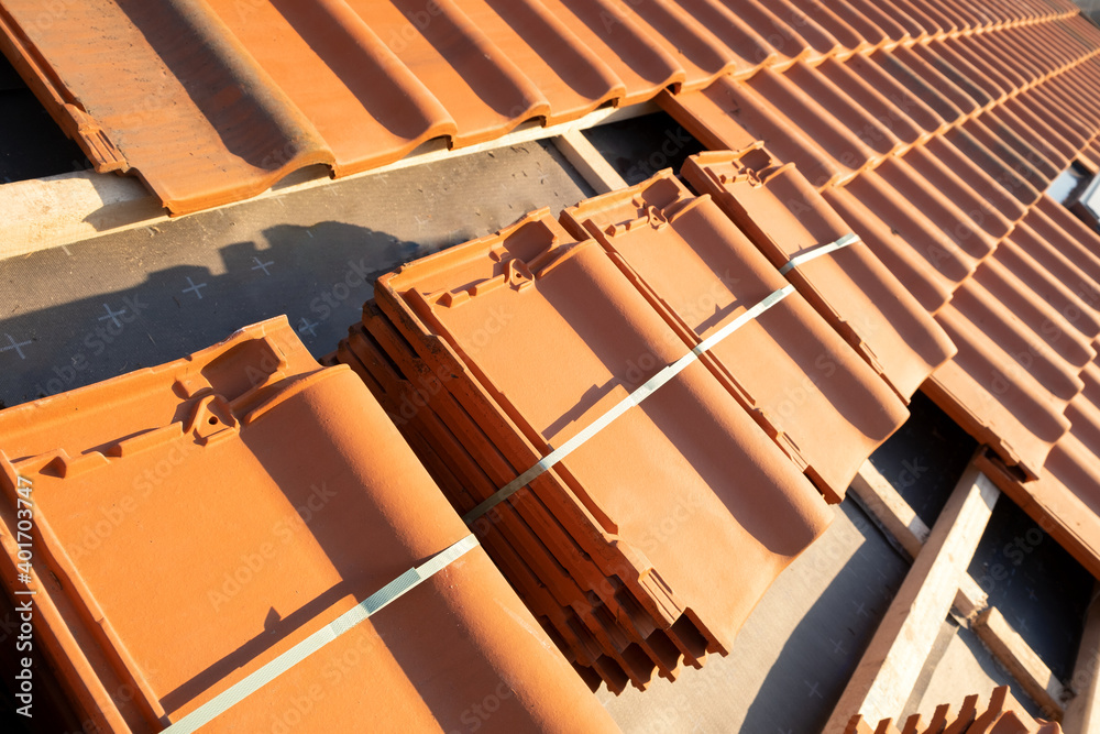 Stacks of yellow ceramic roofing tiles for covering residential ...