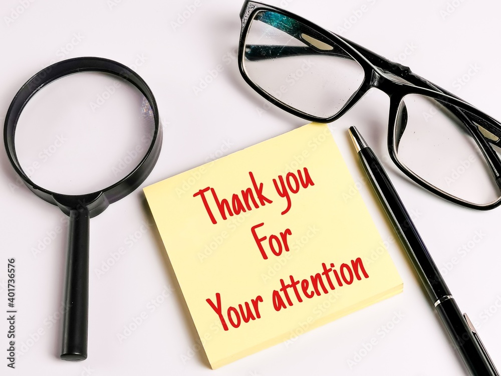 Phrase Thank you for your attention on yellow paper note with a pen ...