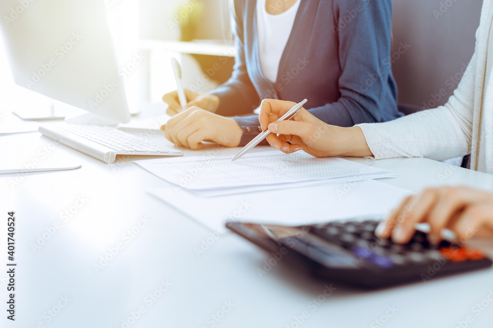 Accountant checking financial statement or counting by calculator ...