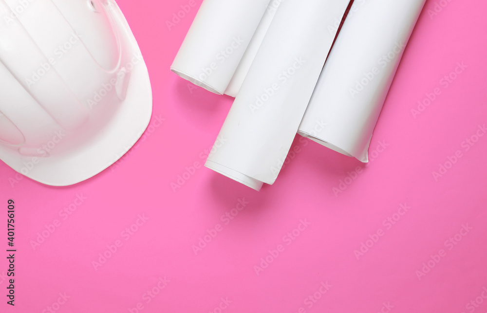 Engineering construction safety helmet, drawing rolls on pink ...