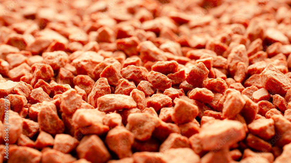 Potassium chloride is a red mineral fertilizer close-up. Red background ...