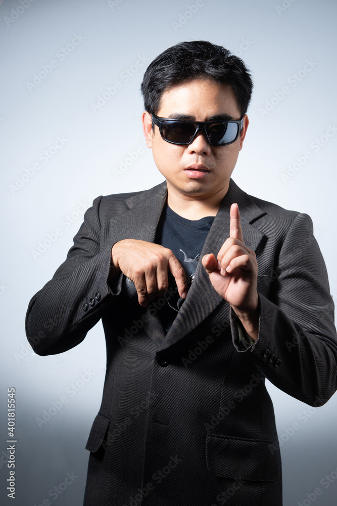 Portrait of Asian short hair bodyguard man wear sunglasses and dark ...
