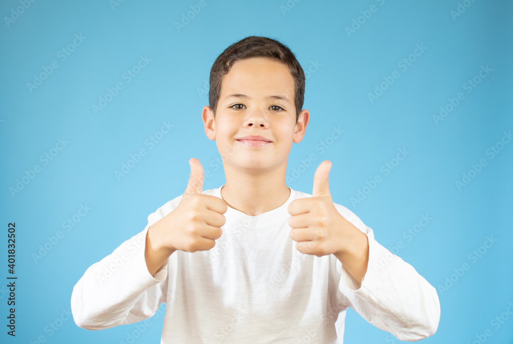 Beautiful caucasian boy shows a gesture with his thumb up with both ...