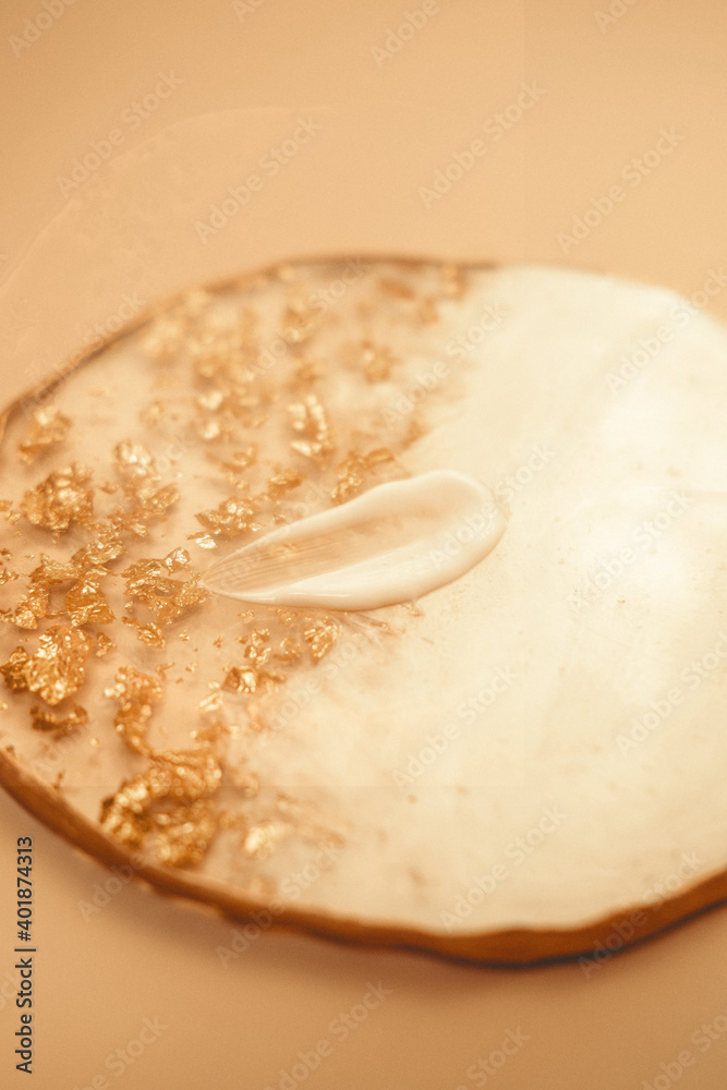 Cosmetic cream smear stroke texture. Epoxy resin gold colored round ...