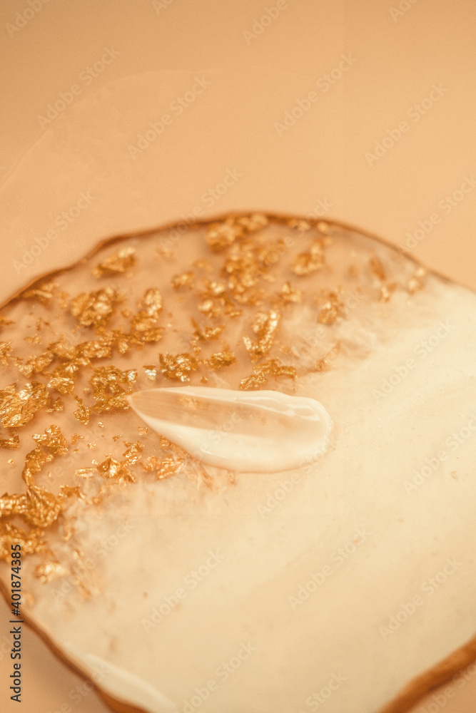 Cosmetic cream smear stroke texture. Epoxy resin gold colored round ...