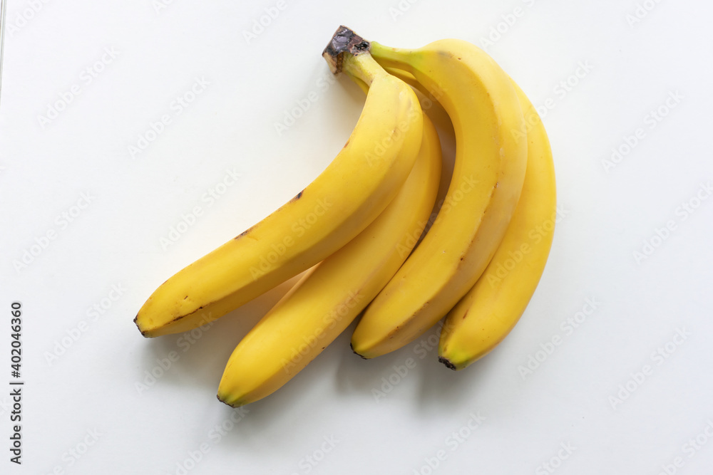 bunch of semi ripe cavendish bananas on white background. top view ...