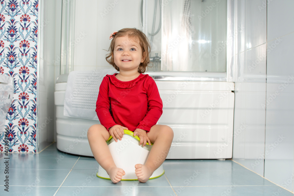 Beautiful smiling little baby sitting on potty in bathroom. Cute ...