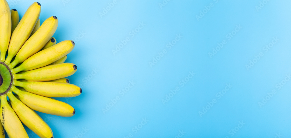 Bananas background. Bananas on a pure blue banner background. Summer ...