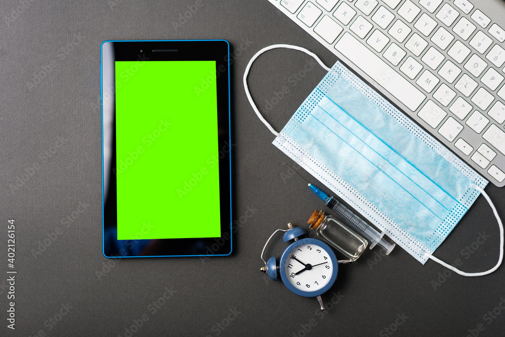 Covid 19 vaccine news on green screen on tablet. Stock Photo | Adobe Stock