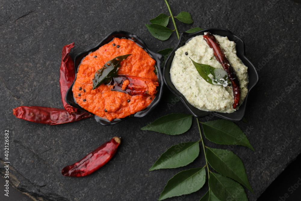 Variety of South Indian Chutney like coconut, tomato served in bowls ...