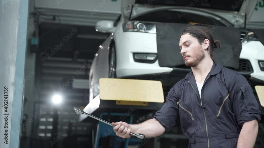 Car mechanic showing skill to control hand tools for car repair, an ...