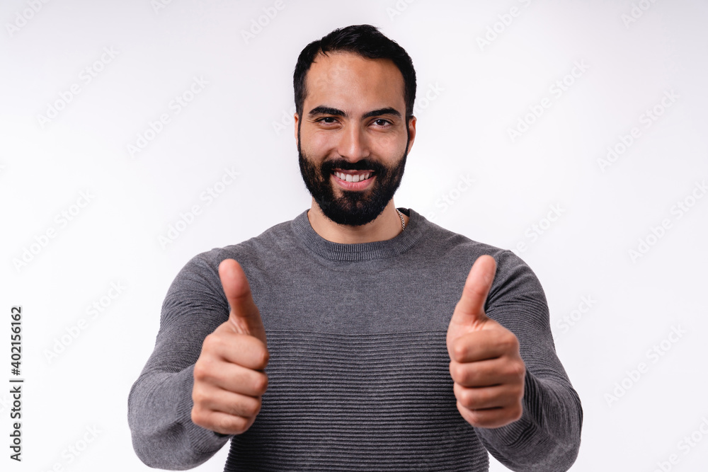 Handsome islamic man in mid 20s showing thumbs up isolated over white ...