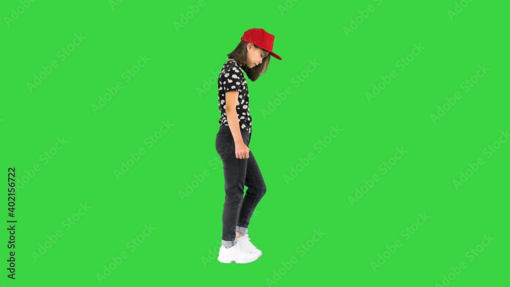 Cute asian girl walking and looking at her feet on a Green Screen ...