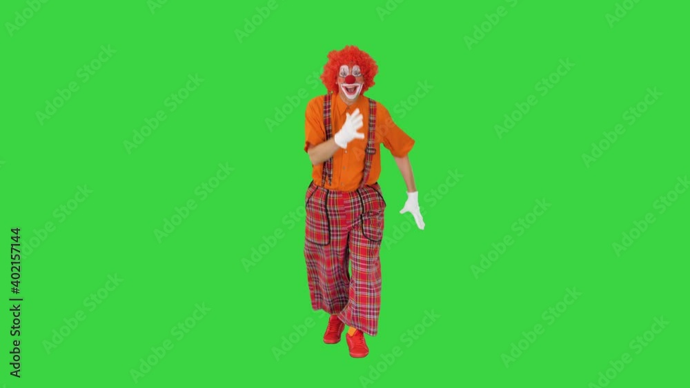Happy clown in red outfit prowling on a Green Screen, Chroma Key. vídeo ...